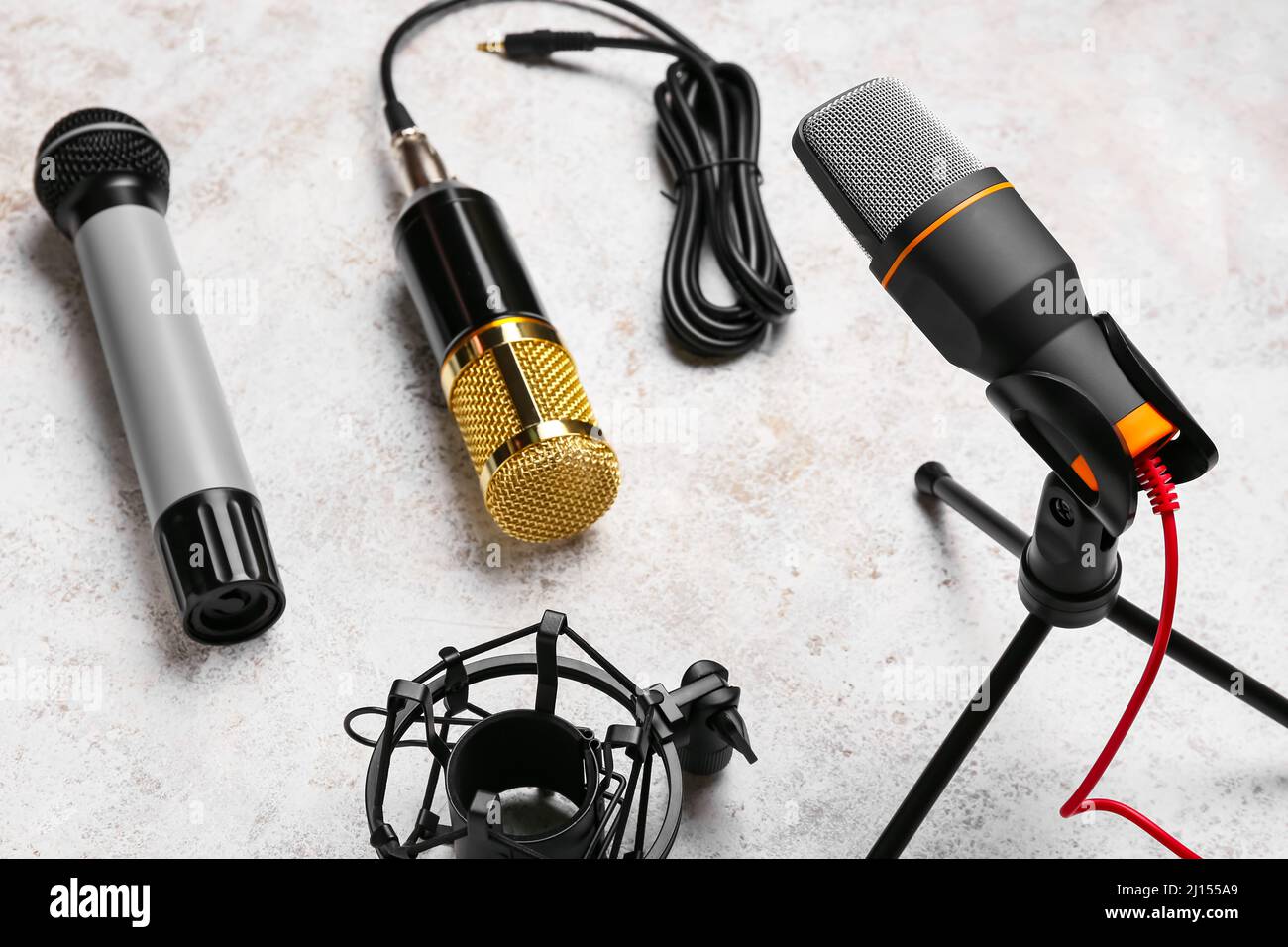 Modern microphones on light background Stock Photo - Alamy