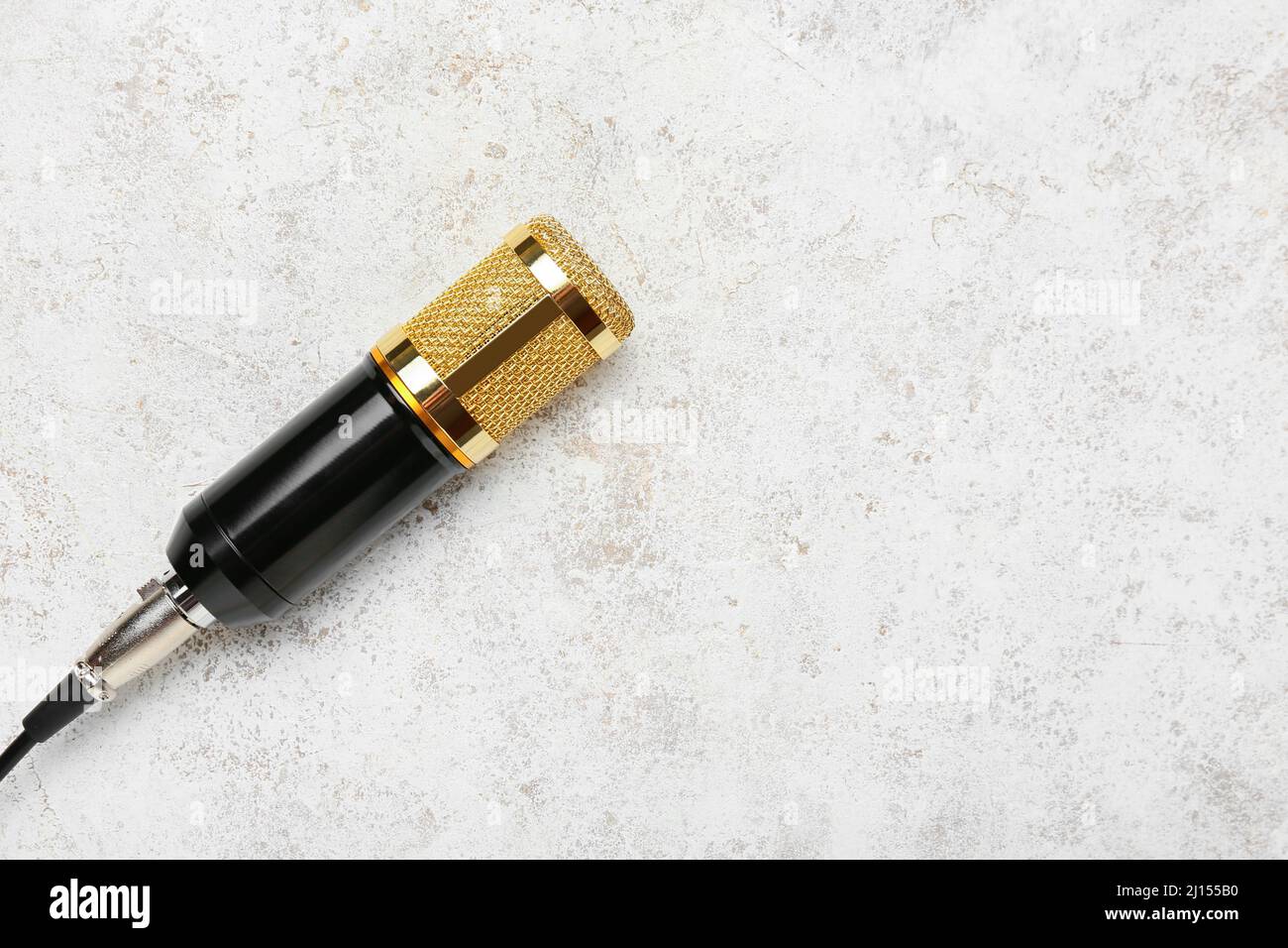 Modern microphone on light background Stock Photo - Alamy