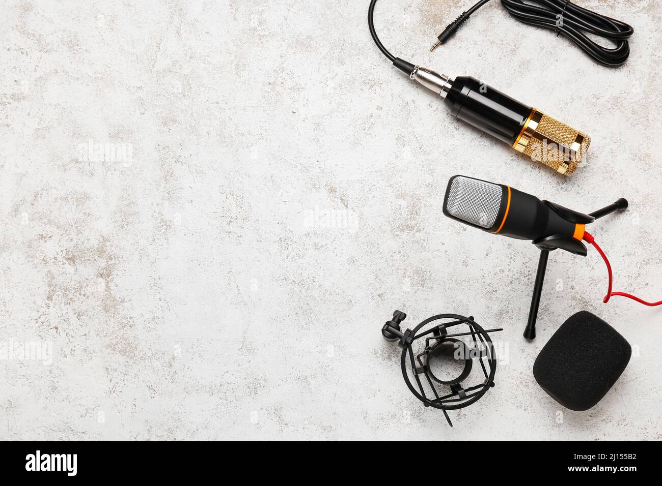 Modern microphones on light background Stock Photo - Alamy