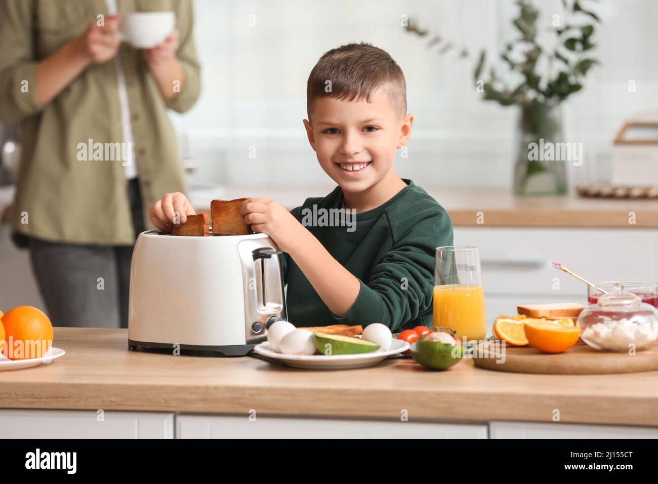 Little boy making tasty toasts in kitchen Stock Photo - Alamy