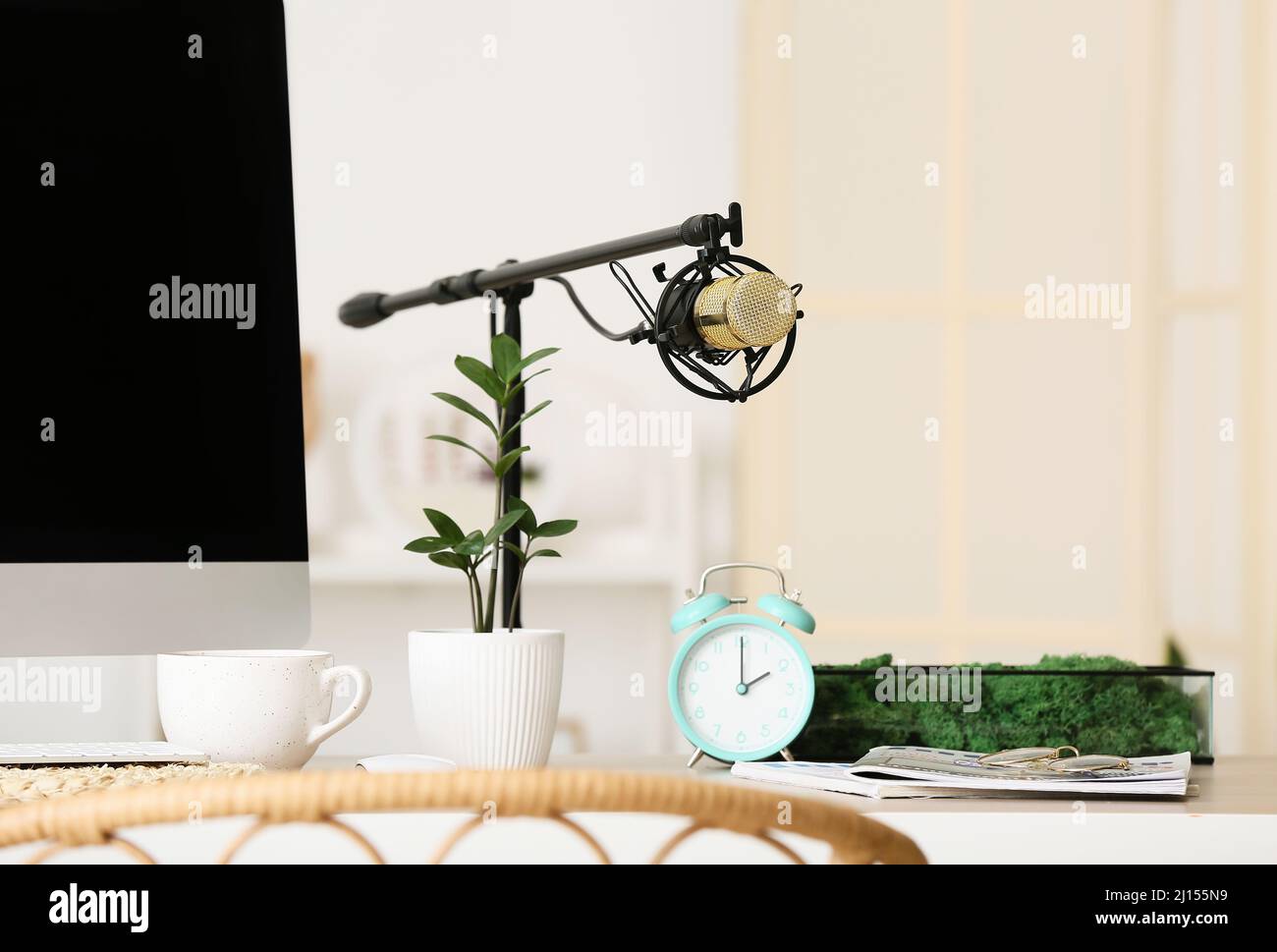 Modern microphone on table in room Stock Photo - Alamy