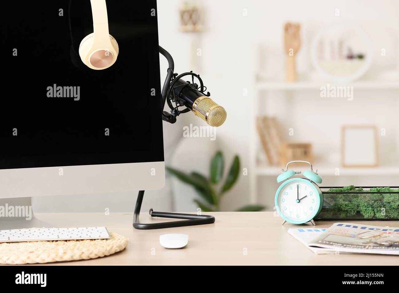 Modern workplace with microphone and computer in room Stock Photo - Alamy