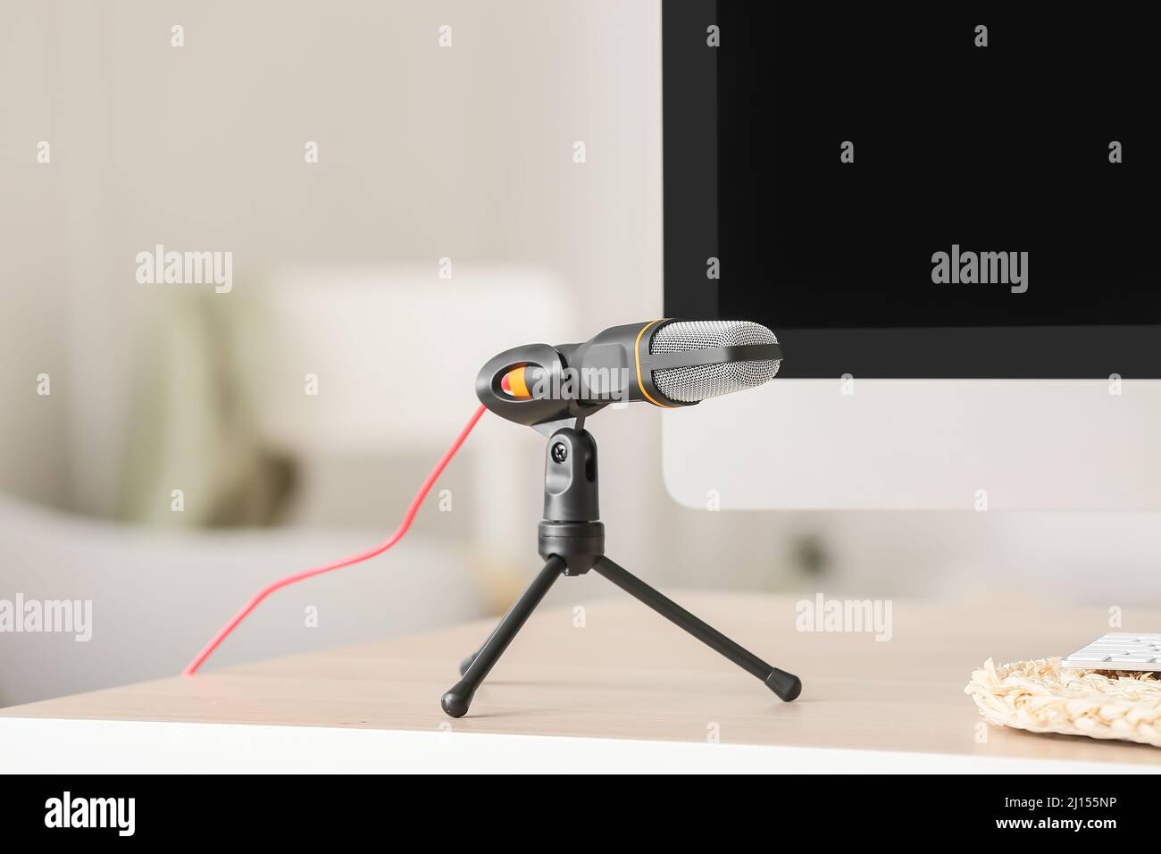 Modern microphone on table in room, closeup Stock Photo - Alamy