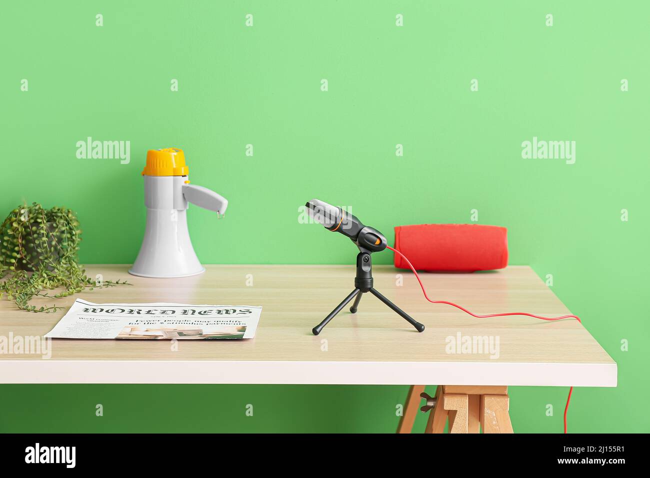 Modern workplace with professional microphone, speaker and megaphone ...