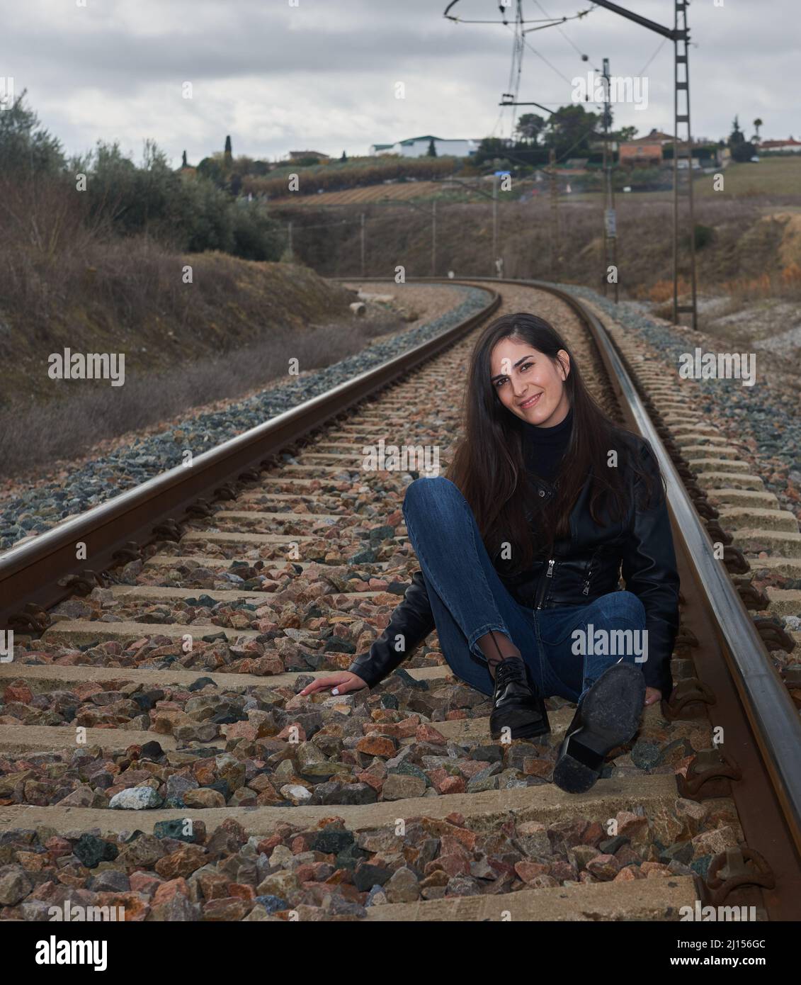 A beautiful young girl sitting quietly on the train rails Stock Photo ...