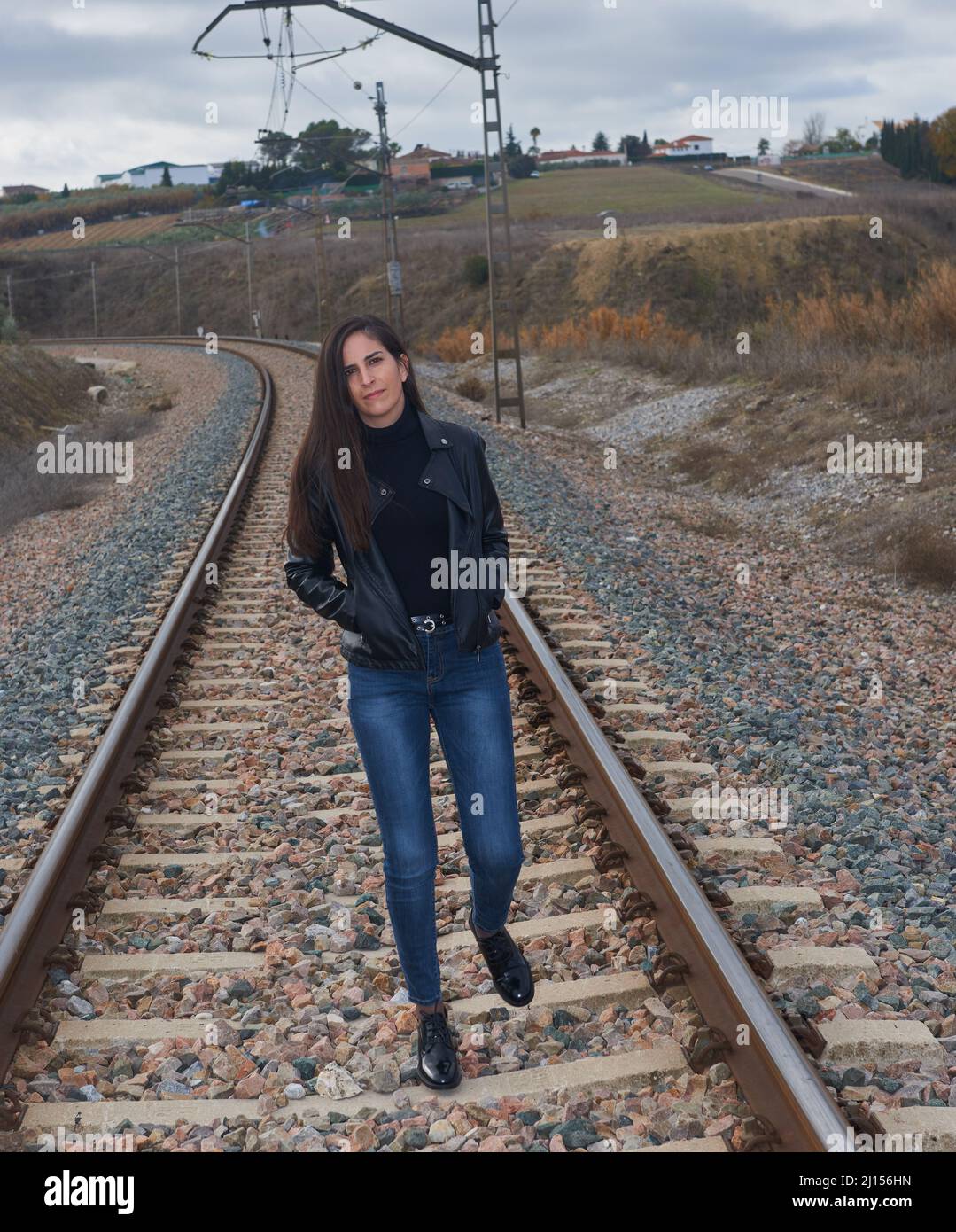 An attractive girl walking quietly on train rails Stock Photo - Alamy