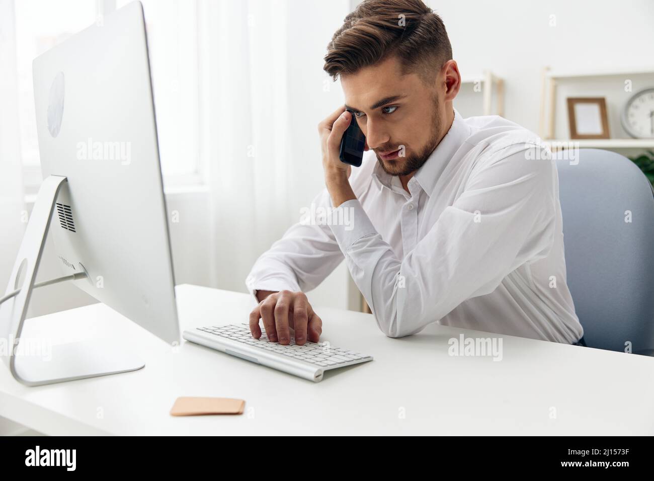 businessmen sitting at a desk in front of a computer with a keyboard ...
