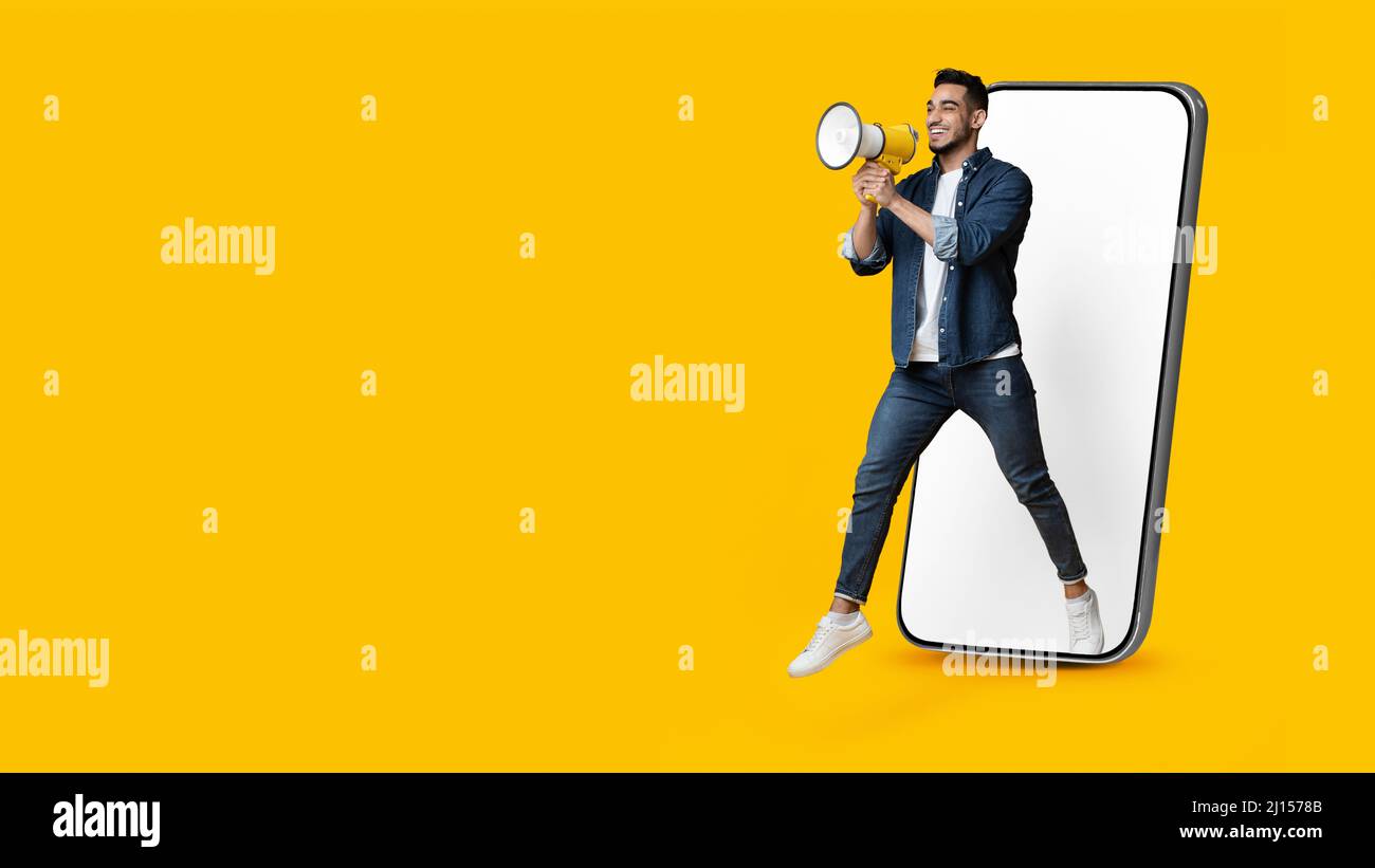Man jumping out of smartphone with empty screen, making announcement ...