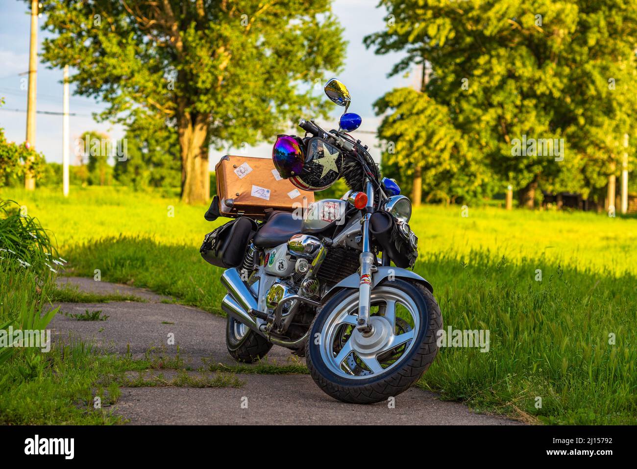 Silver motorcycle cruiser stands by the road Stock Photo - Alamy