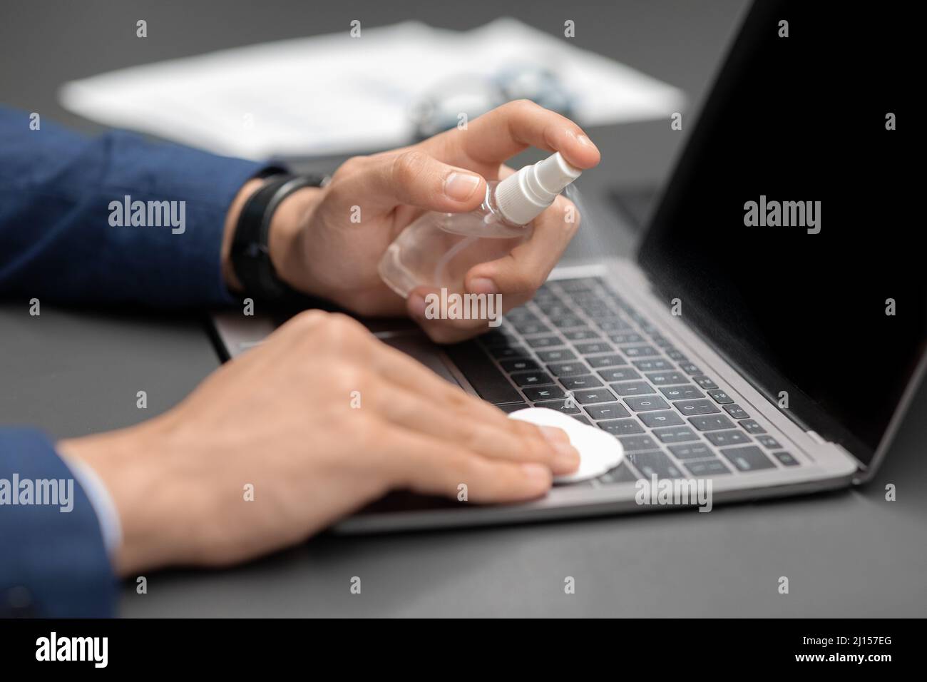 Unrecognizable man in suit cleaning laptop keyboard Stock Photo - Alamy