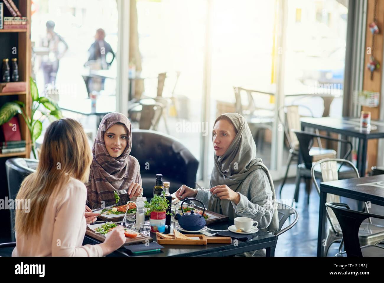 Eat up and catch up. Shot of a group of women getting together for ...