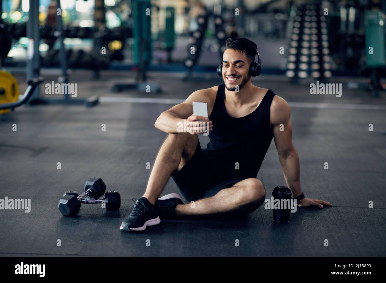 Fitness Application. Smiling Middle Eastern Sportsman Using Smartphone ...