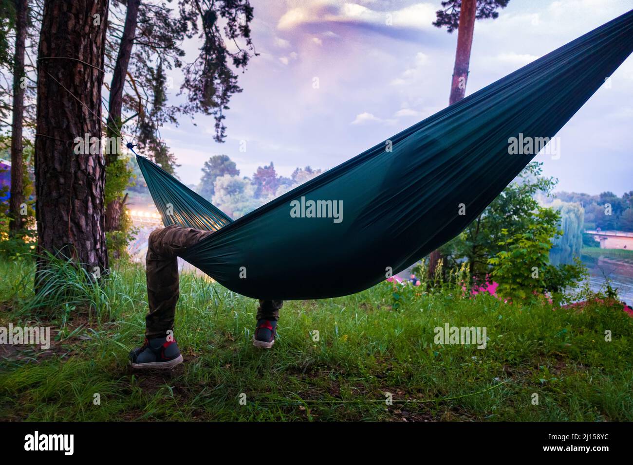 Man resting lying in a hammock outdoors Stock Photo - Alamy