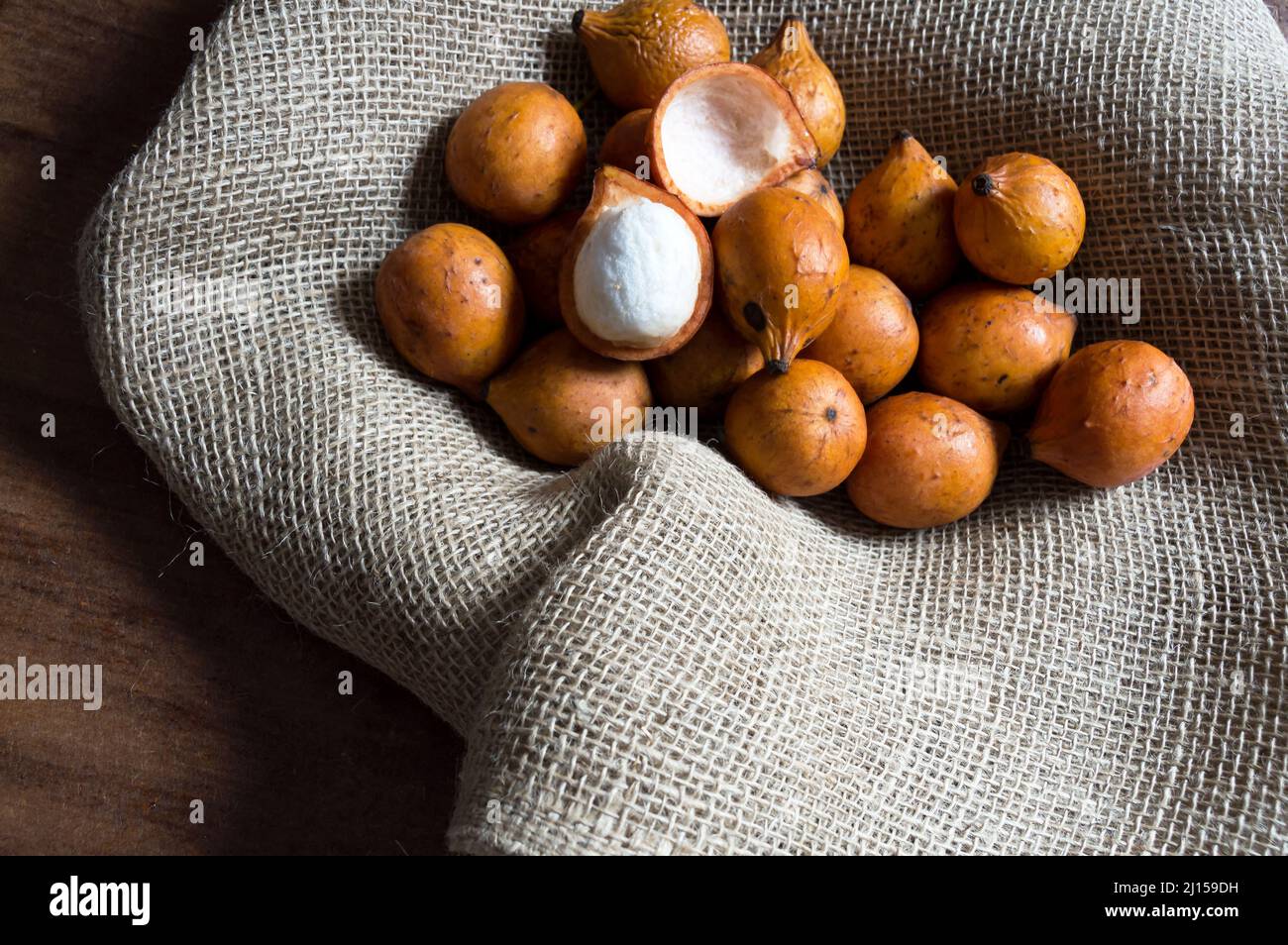 Brazilian fruit named bacupari on a brown table, the fruits are ...