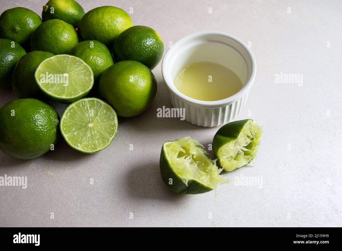 Several lemons on a white background and a split fruit showing the pulp ...