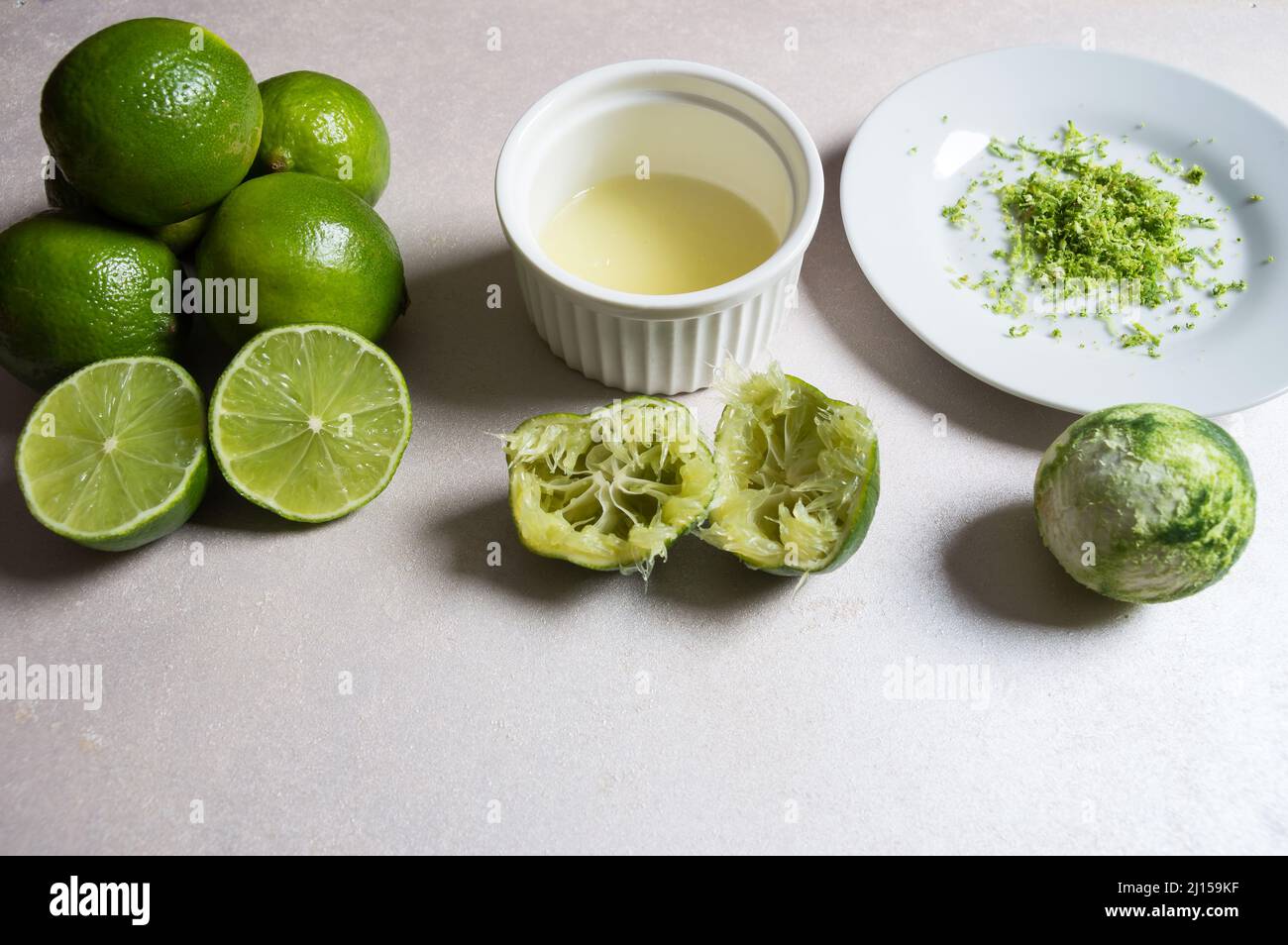 Lemons in different stages on white table, there is a whole lemon ...