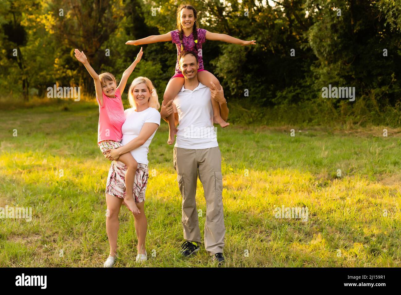 Happy family together bonding outdoors Stock Photo - Alamy