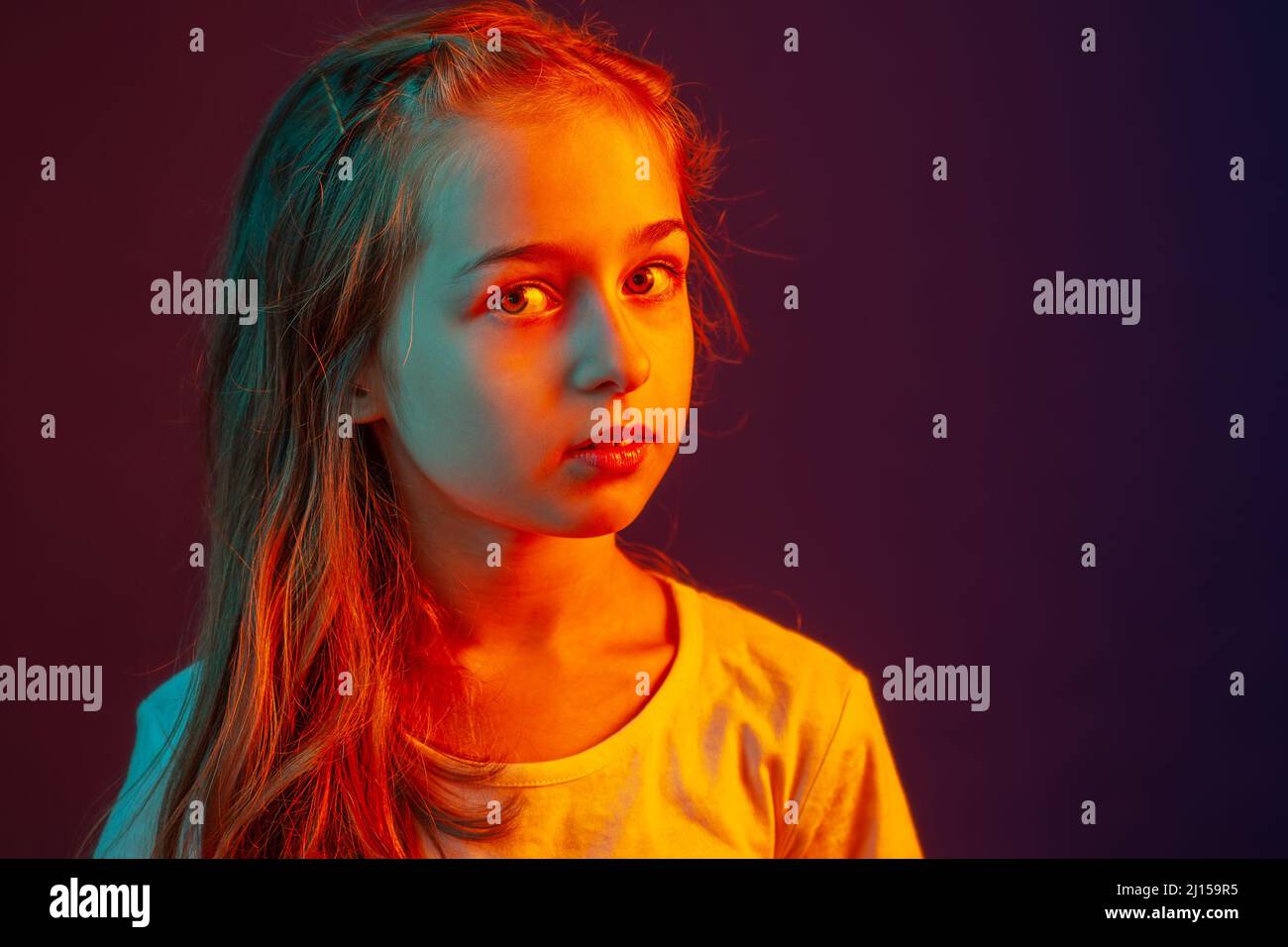 Portrait of a child girl. Girl on a purple background with a color ...