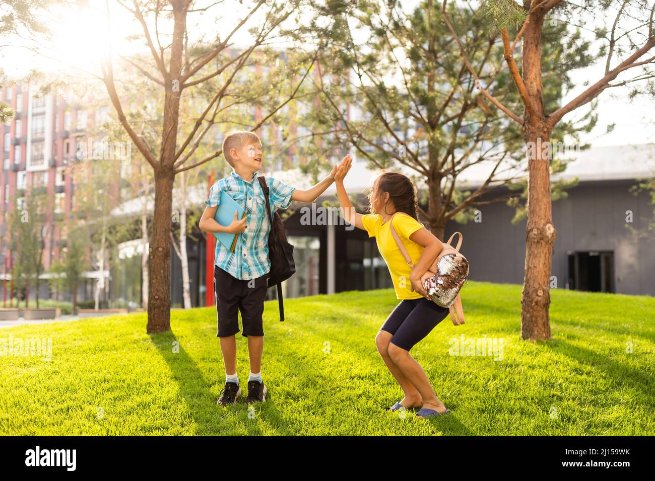 Portrait Of Excited Elementary School Pupils On Playing Field At Break ...