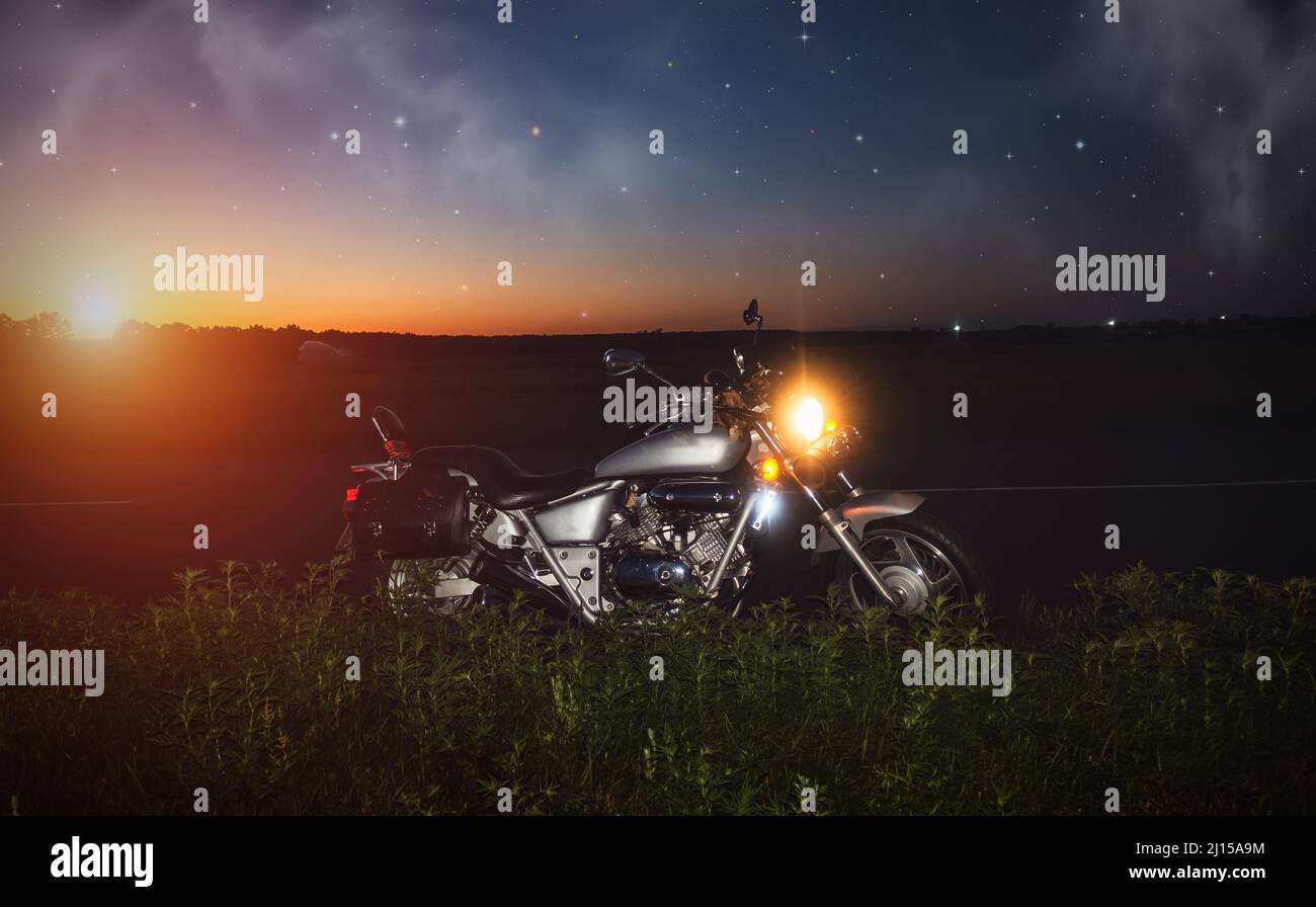 Motorcycle at night in the field. Motorcycle trip Stock Photo - Alamy