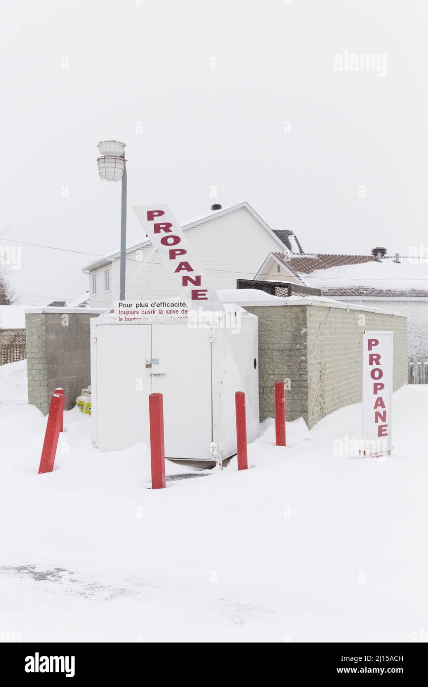 Signs advertising propane on a gas station forecourt during the winter ...