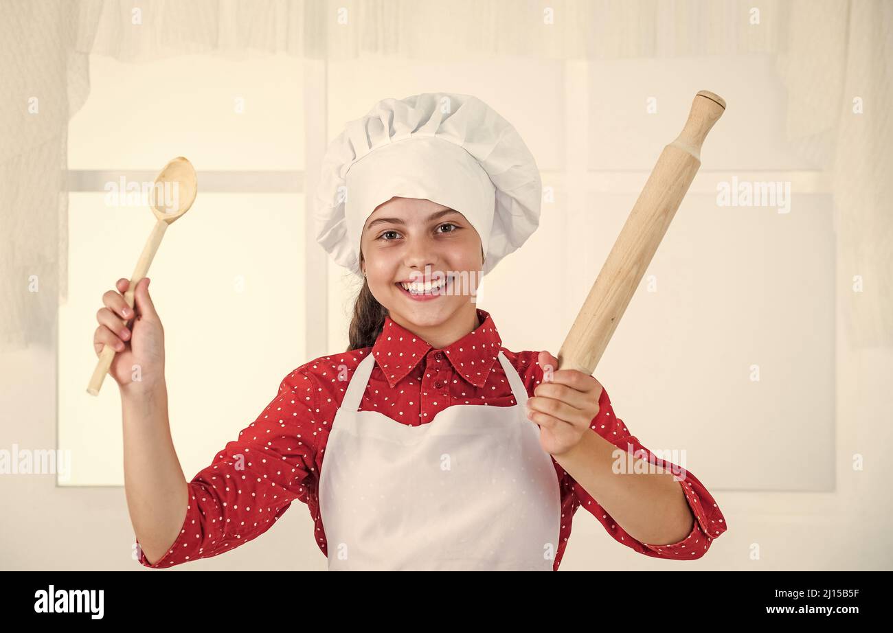 happy kid girl in cook hat and apron in kitchen, chef Stock Photo - Alamy