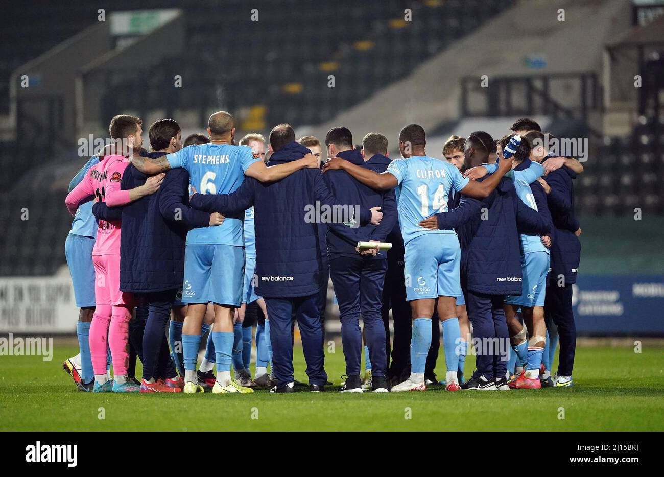 Boreham Wood players and staff have a team huddle on the pitch after ...