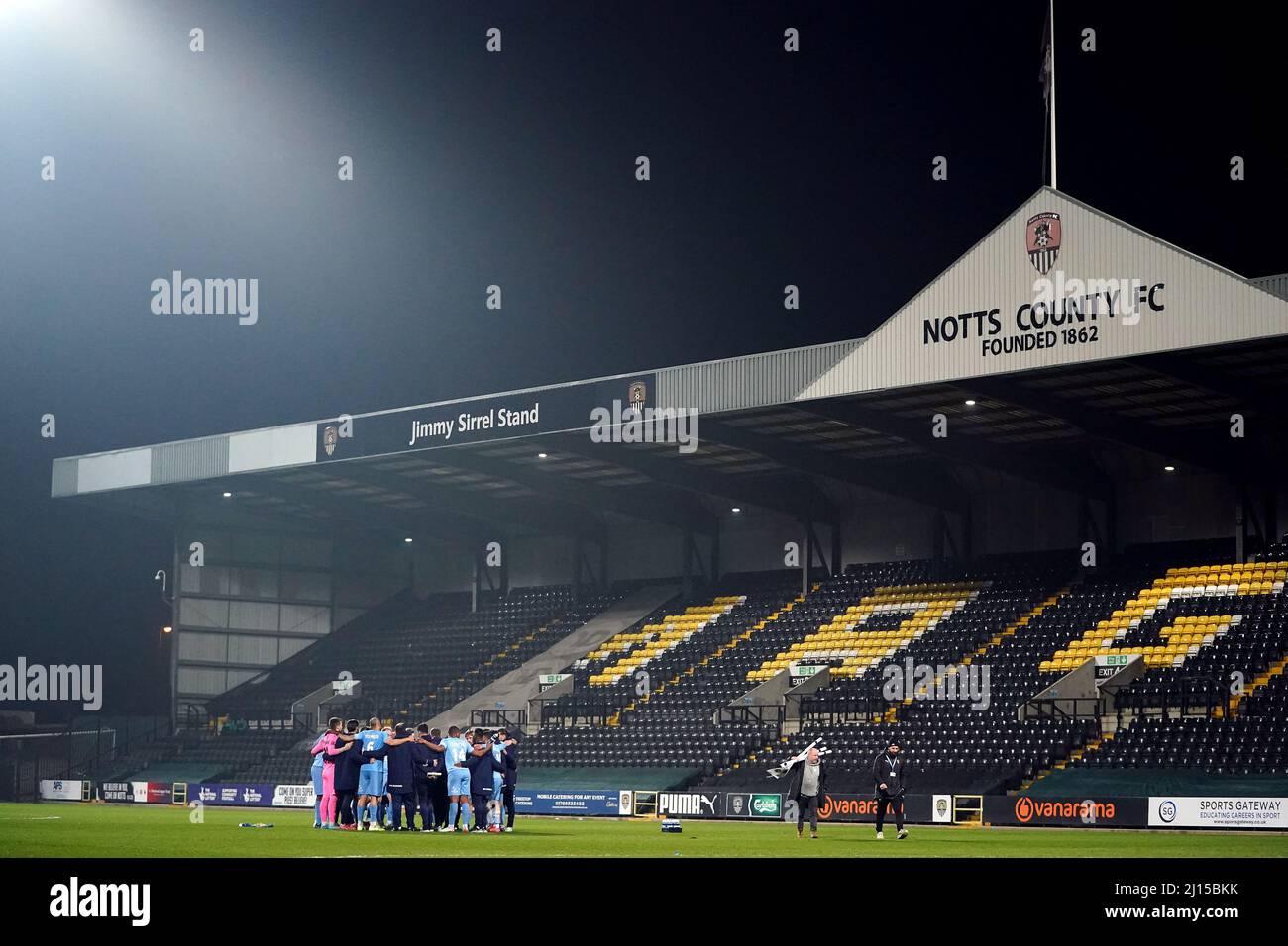 Boreham Wood players and staff have a team huddle on the pitch after ...