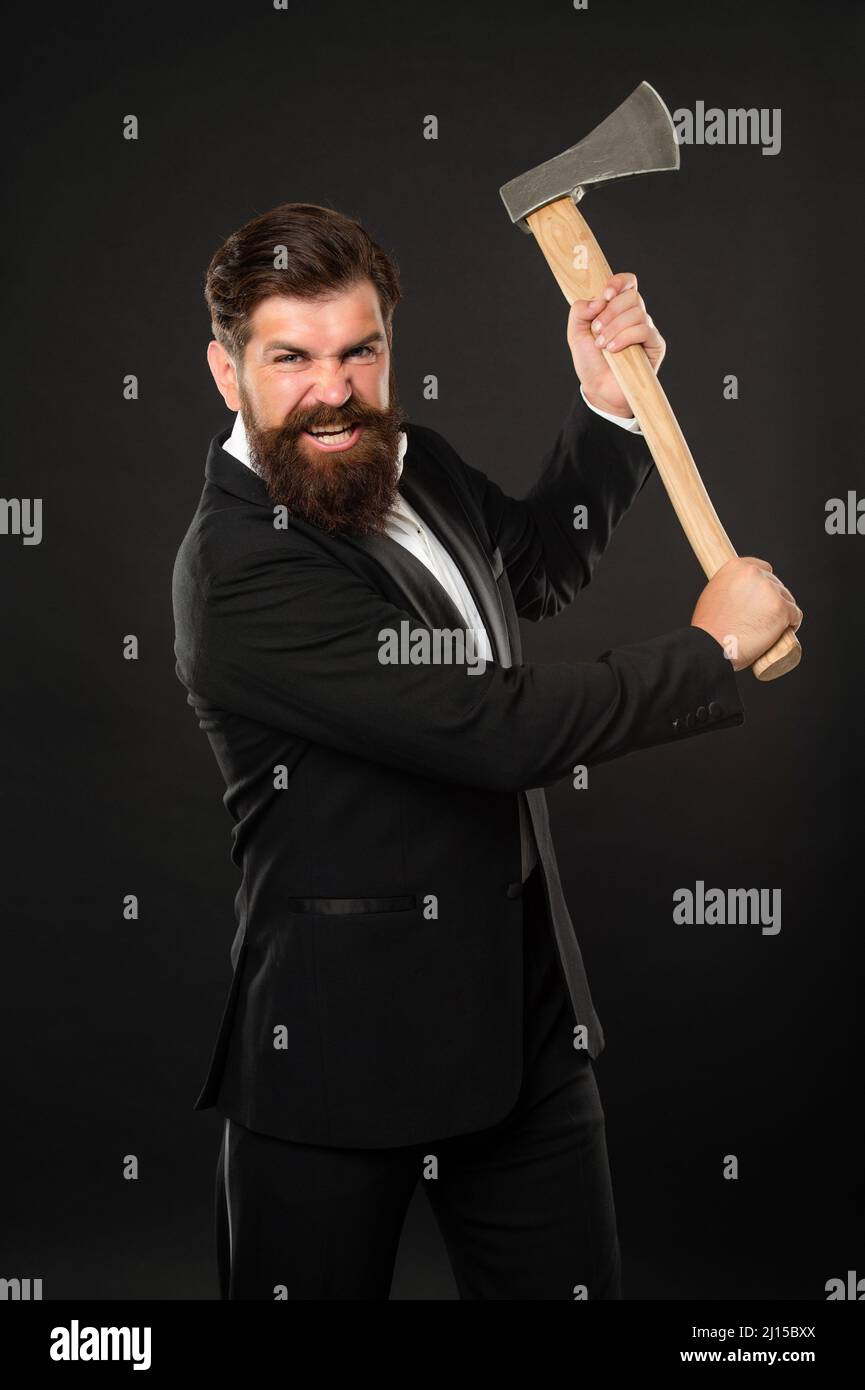 Angry bearded man in suit threatening with axe dark background, anger ...