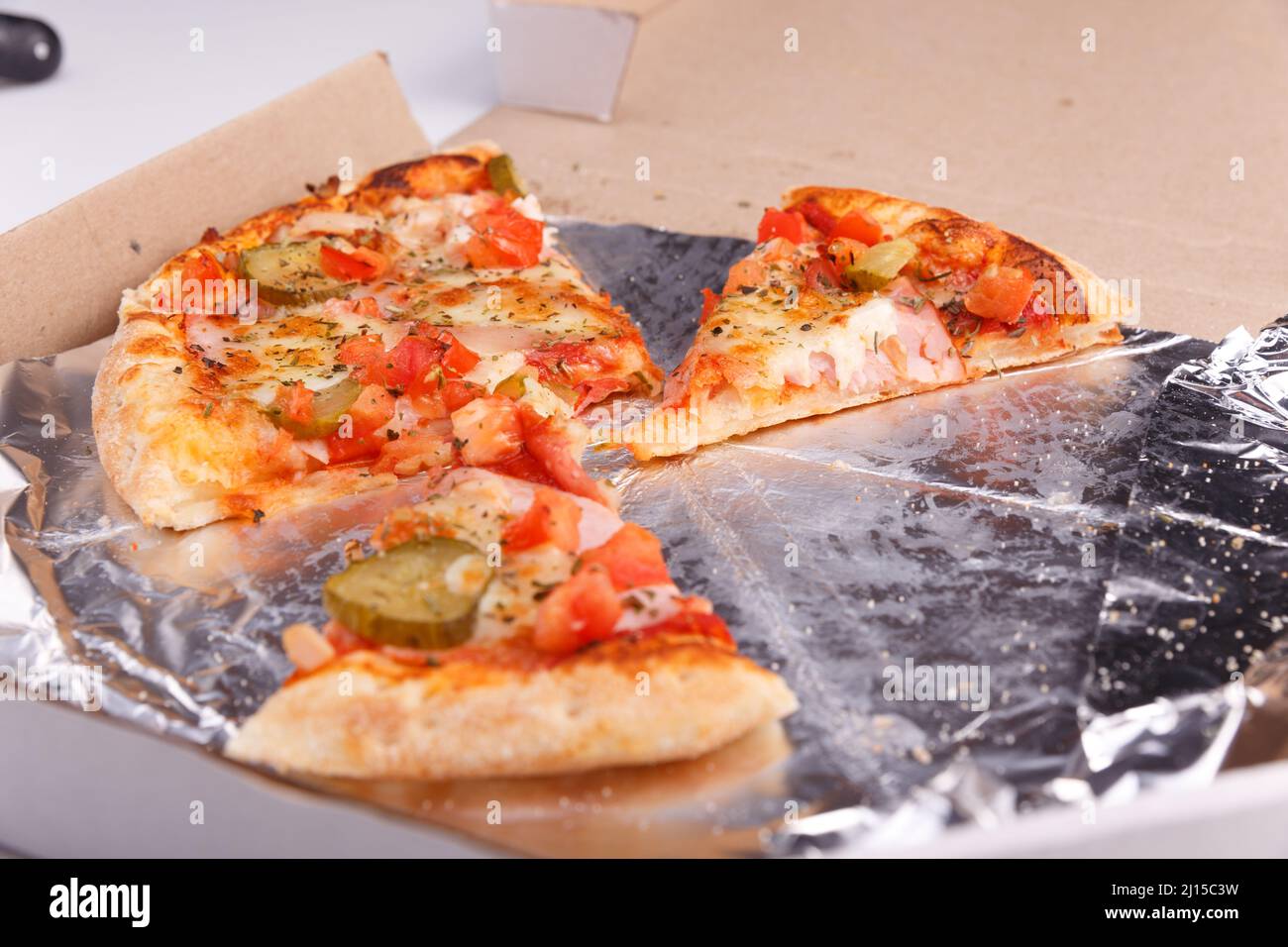 The remaining pizza is in the box. Empty pizza box with three slice ...