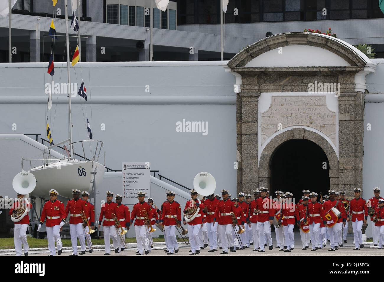 Military band playing wind instruments and music, marching on ...