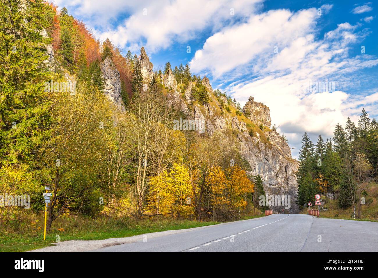 Road through a rocky gorge in a mountain valley at autumn. The Vratna ...