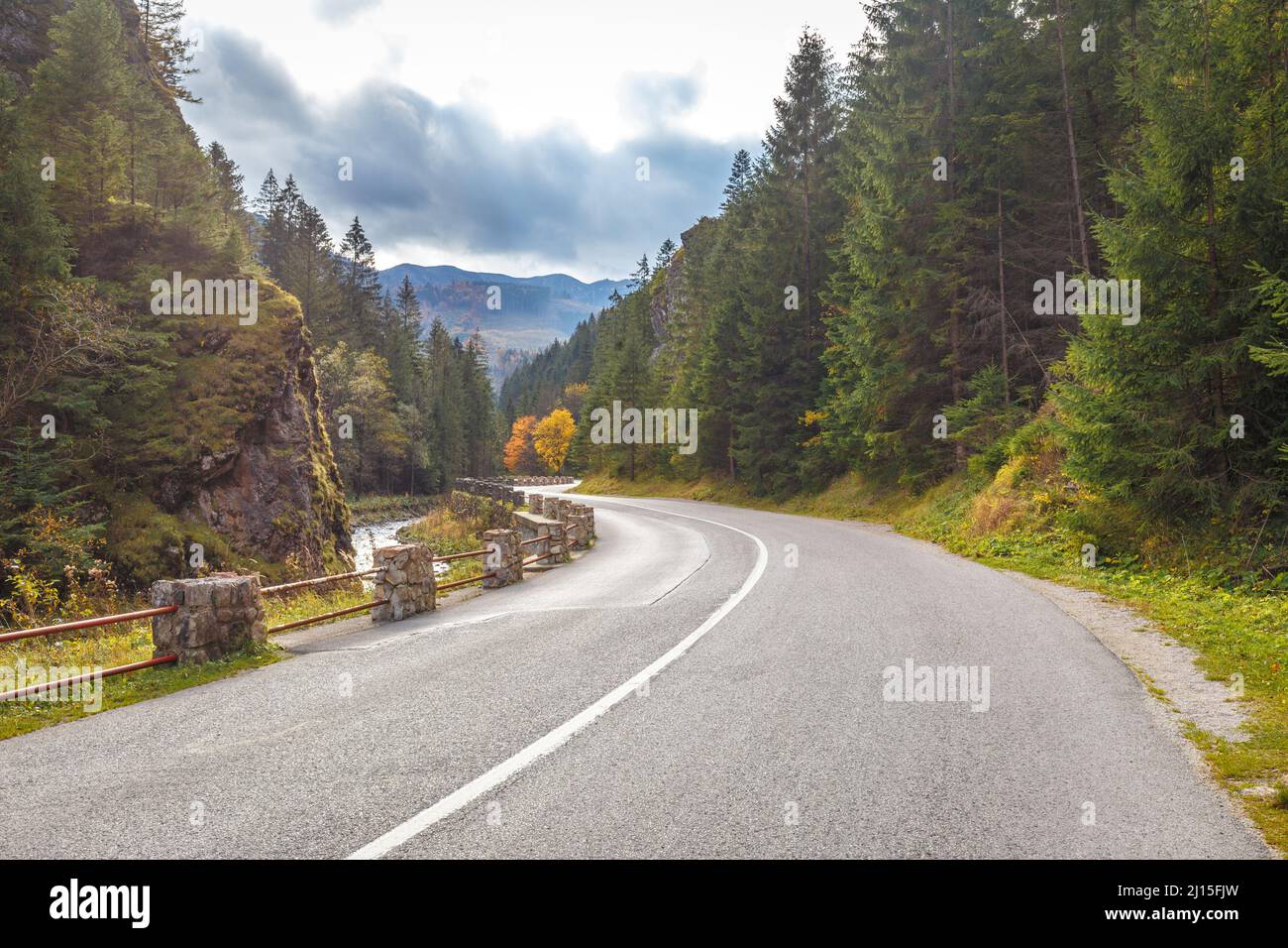 Road through a rocky gorge in a mountain valley at autumn. The Vratna ...