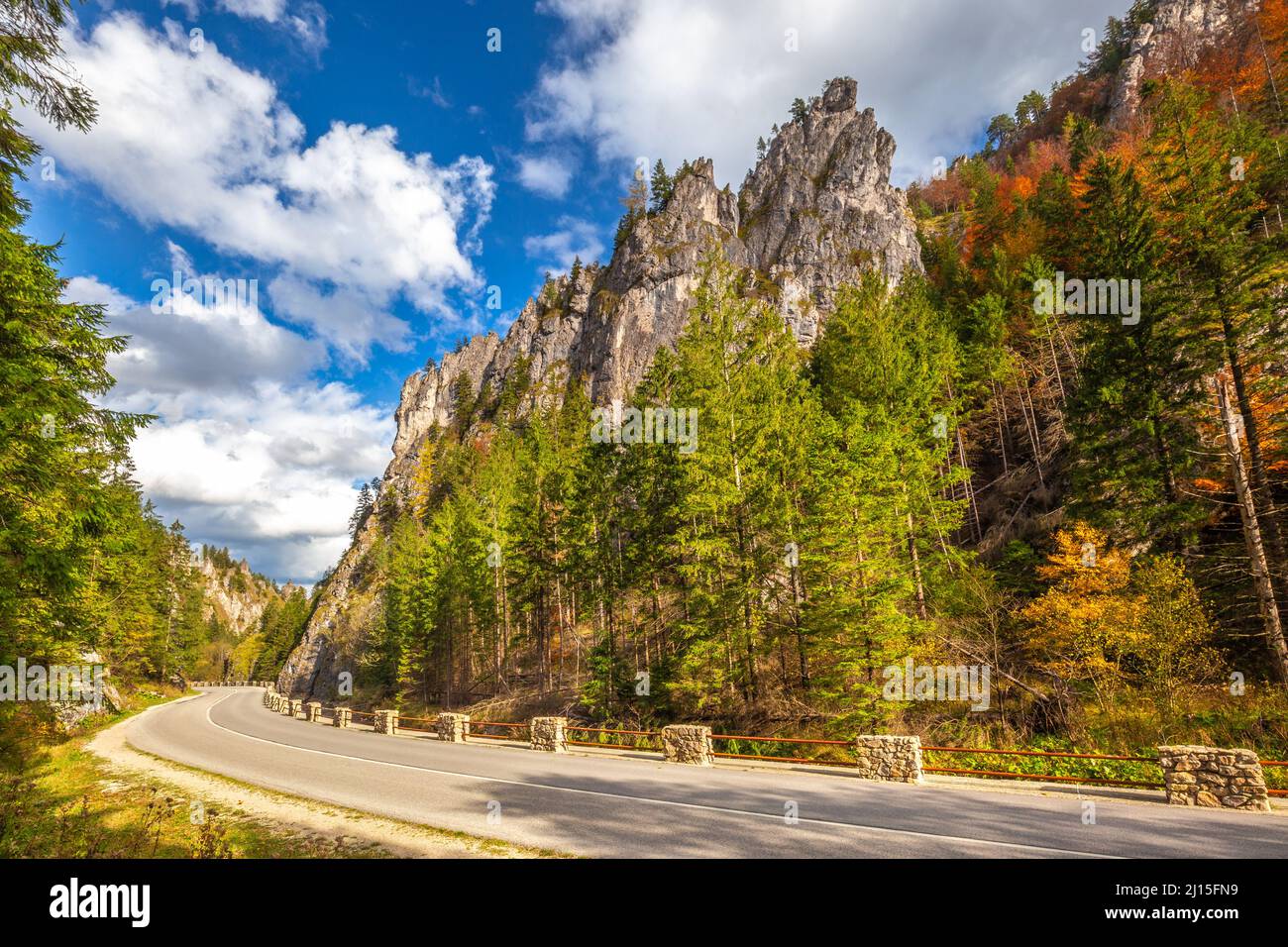 Road through a rocky gorge in a mountain valley at autumn. The Vratna ...