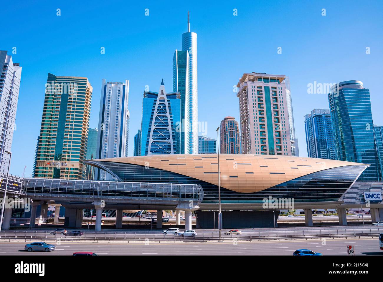 Modern metro station with luxury skyscrapers against blue clear sky ...