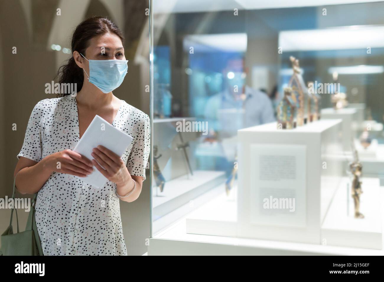 Woman in museum hall Stock Photo - Alamy