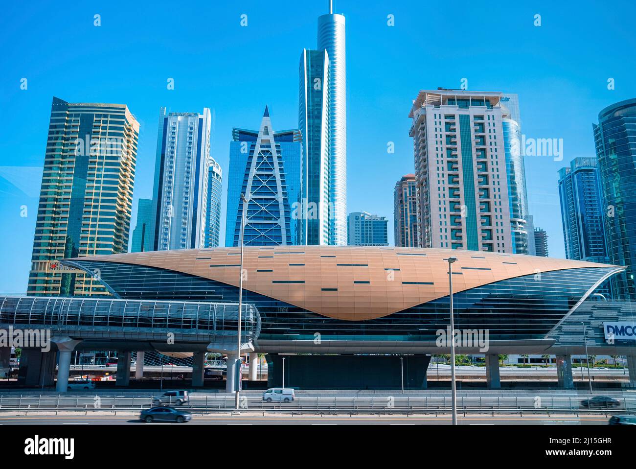 Modern metro station with luxury skyscrapers against blue clear sky ...