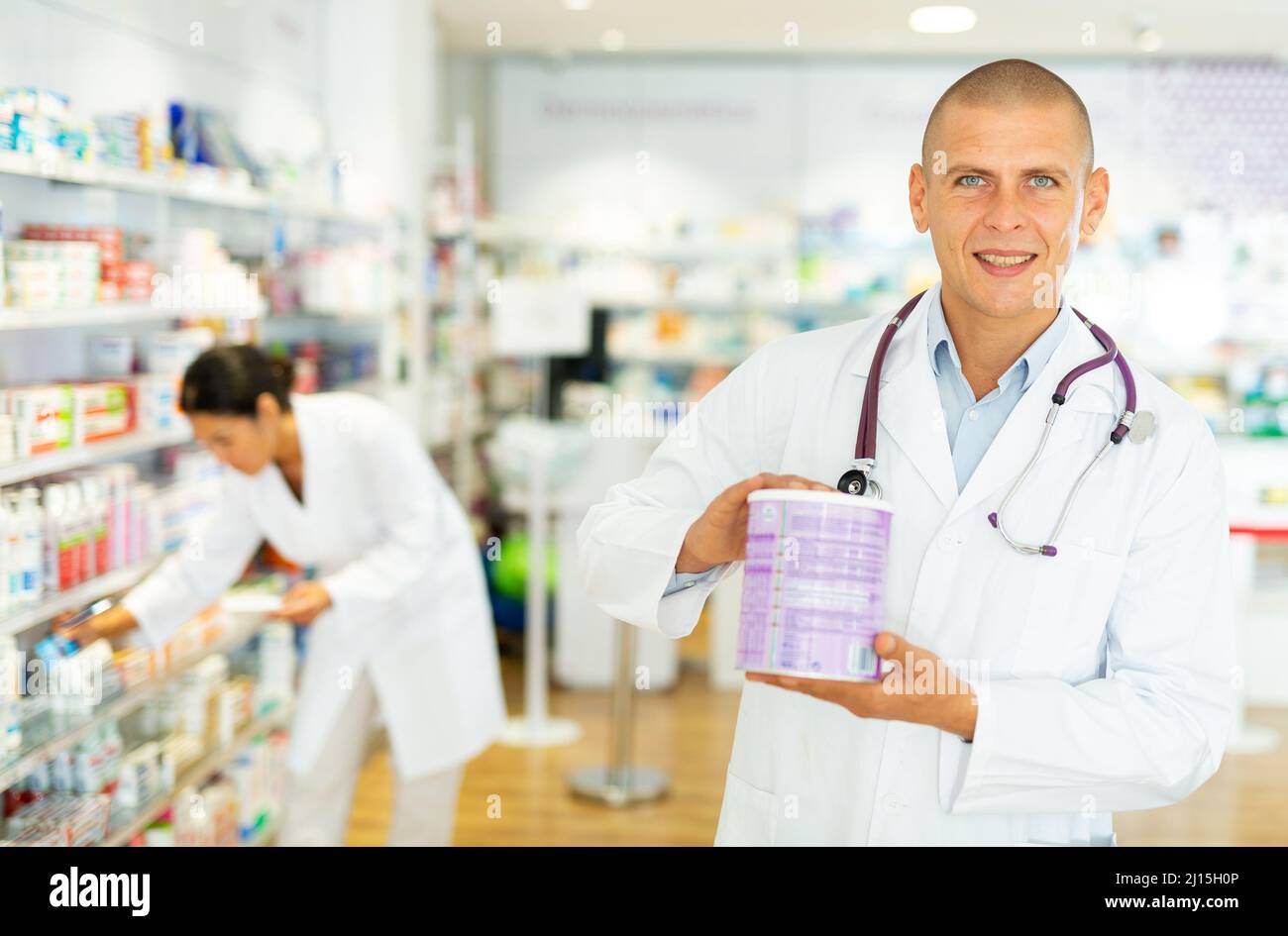 Male pharmacist offers various body care medicines Stock Photo - Alamy