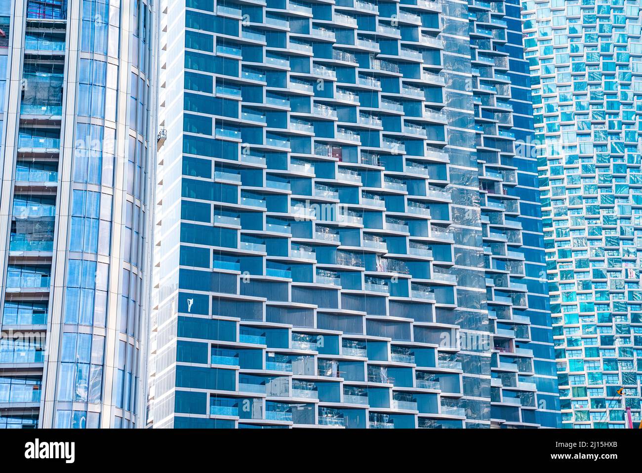Full frame view of glass windows and balconies of residential tower ...