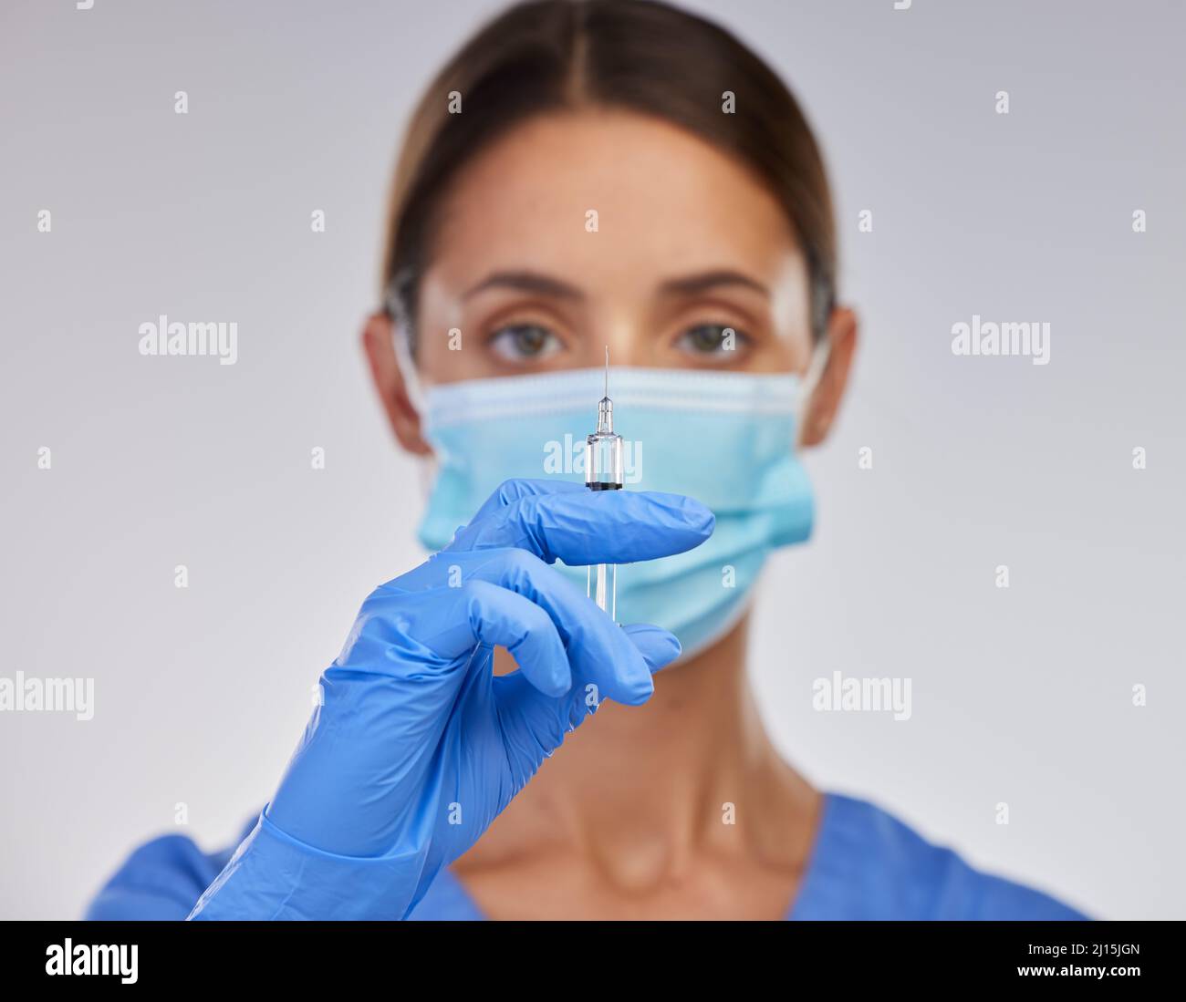 This is for your own protection. Shot of a young female nurse holding a ...