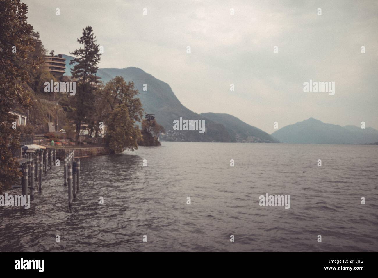 Gloomy day on Lake Lugano with autumn trees in Switzerland Stock Photo ...