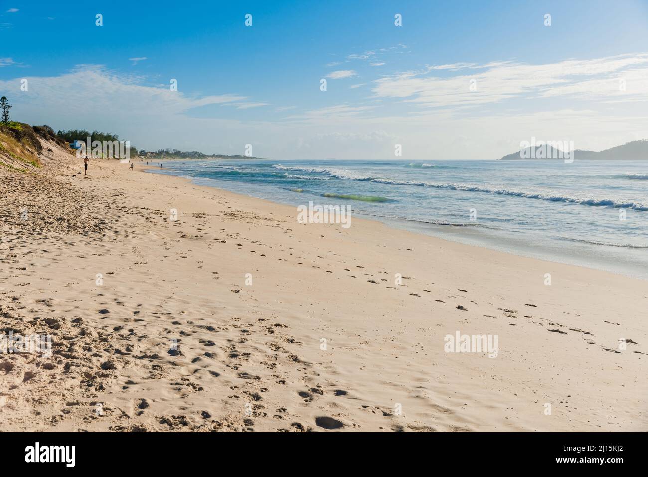 Holiday beach and blue ocean with waves in Brazil. Morro das Pedras ...