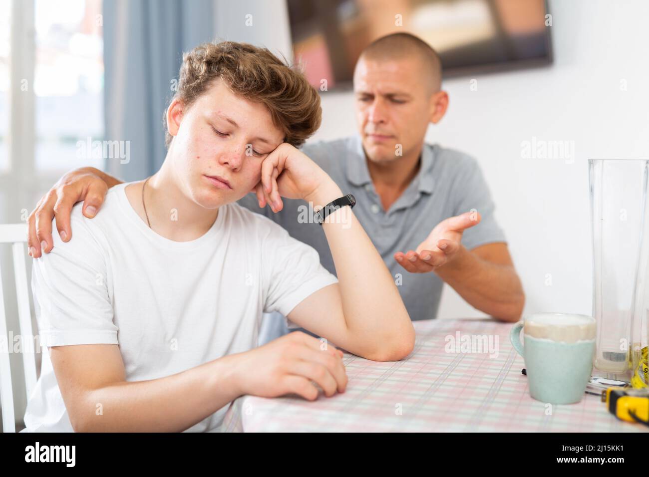 Father comforting his son Stock Photo - Alamy