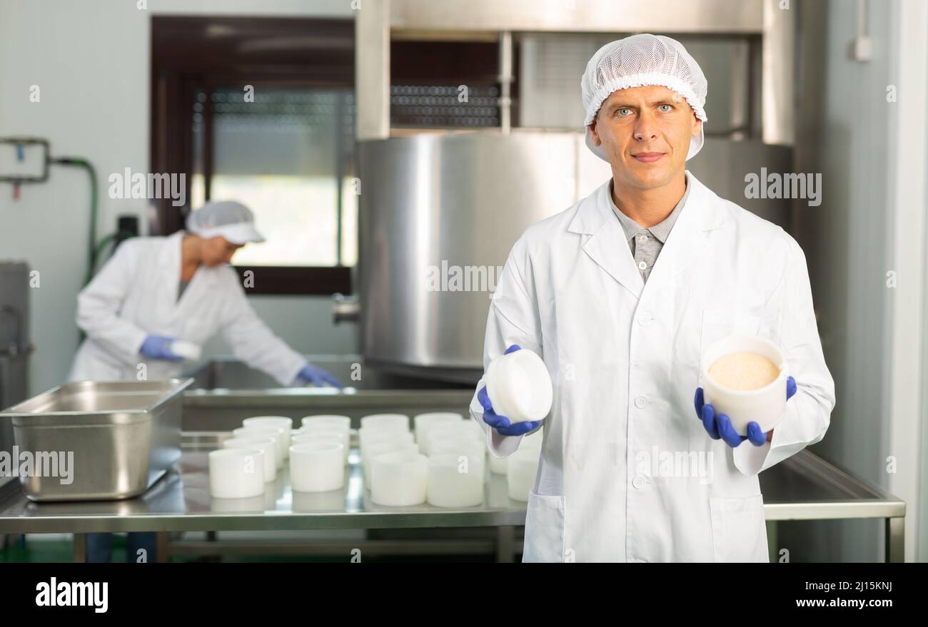 Young man cheese wheel hi-res stock photography and images - Alamy