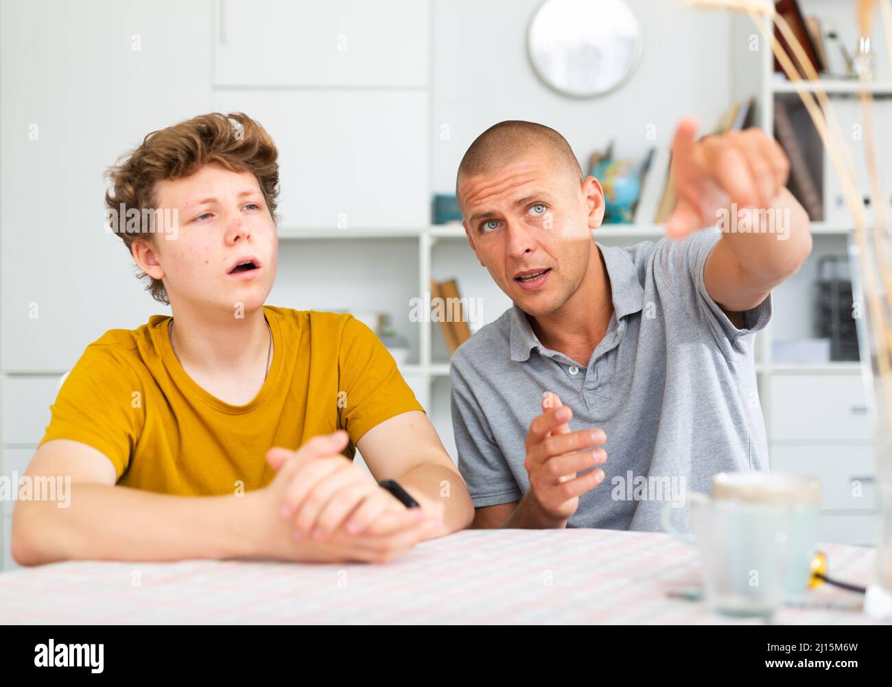 Portrait of guy with his father who are resting together at home Stock ...