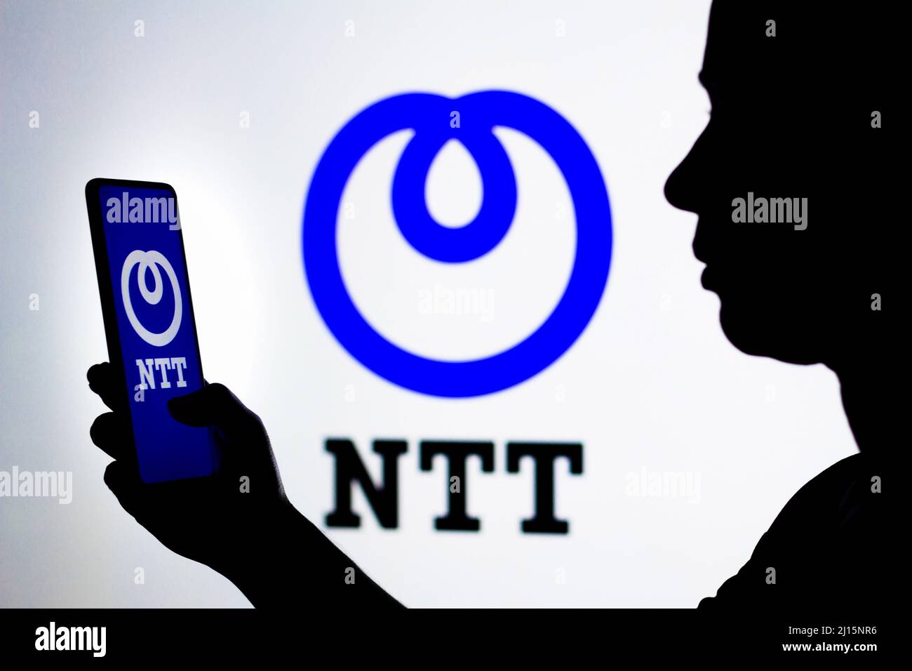 In this photo illustration, a woman's silhouette holds a smartphone ...