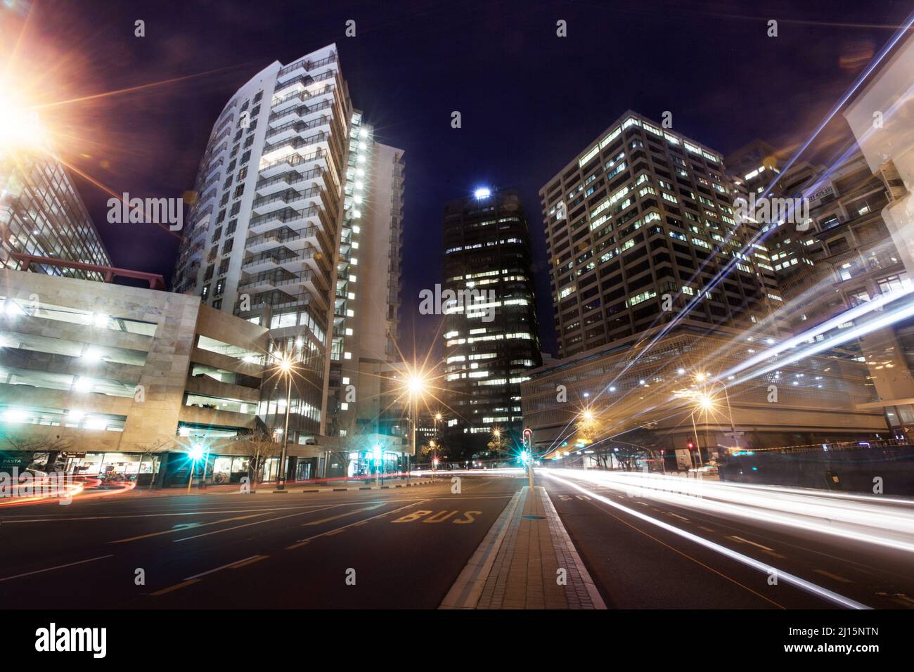 The hustle and bustle of a busy street. A city scene at night Stock ...