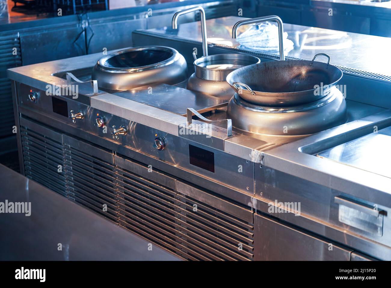 Pots and cooktops in restaurant commercial kitchens Stock Photo - Alamy