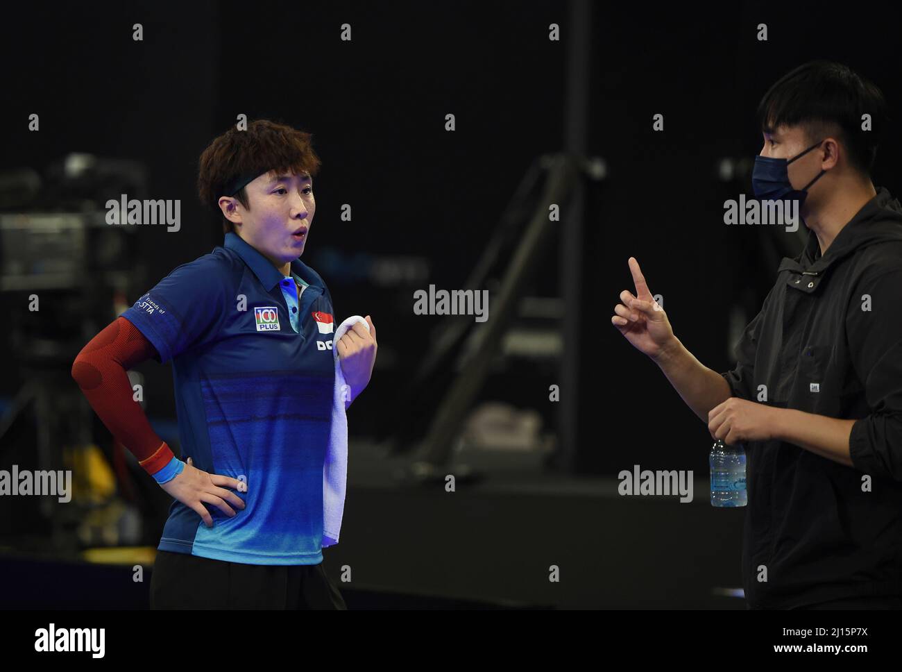 Doha, Qatar. 22nd Mar, 2022. Feng Tianwei (L) of Singapore listens to ...