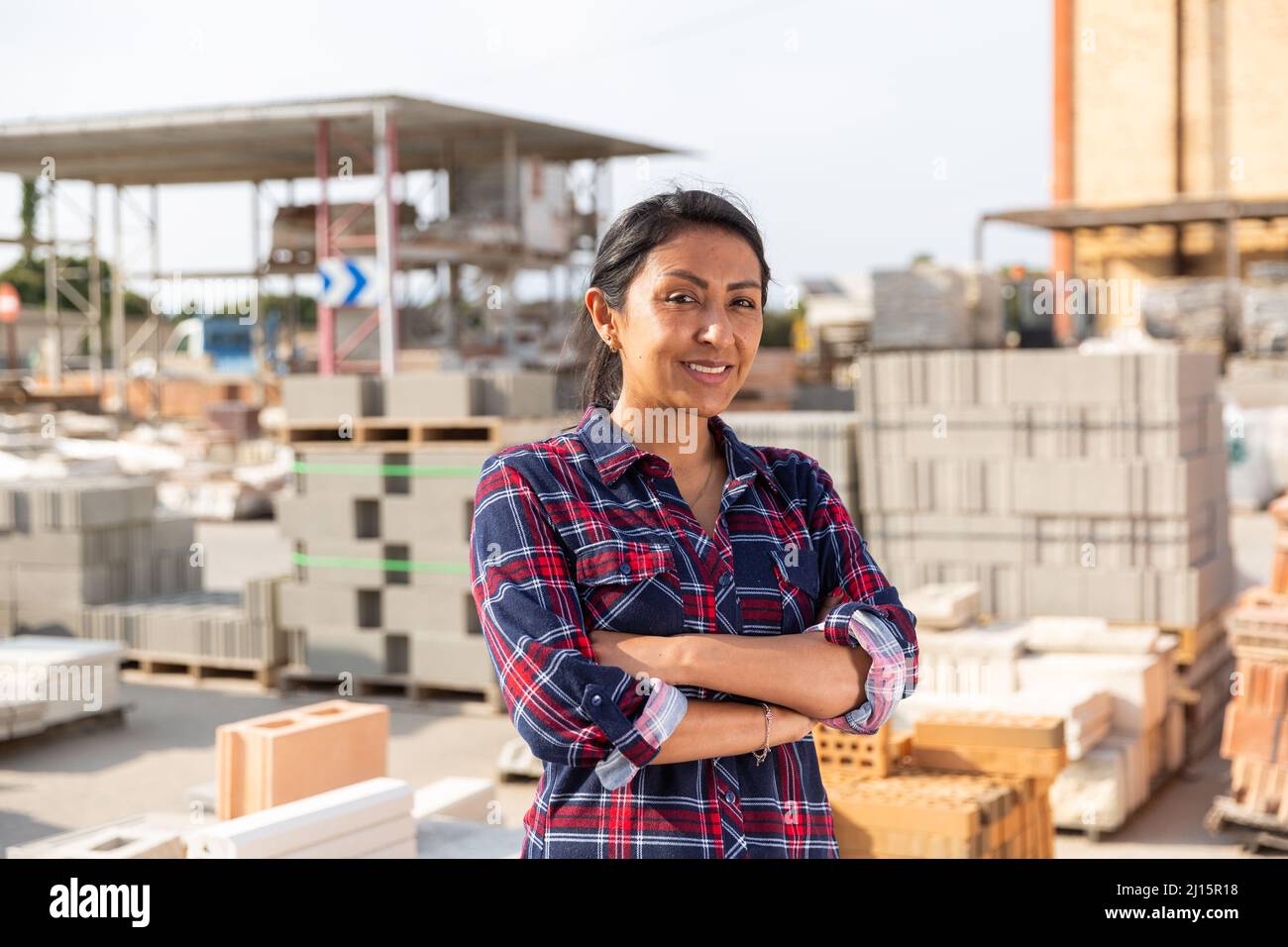 Woman worker posing at building materials warehouse Stock Photo - Alamy